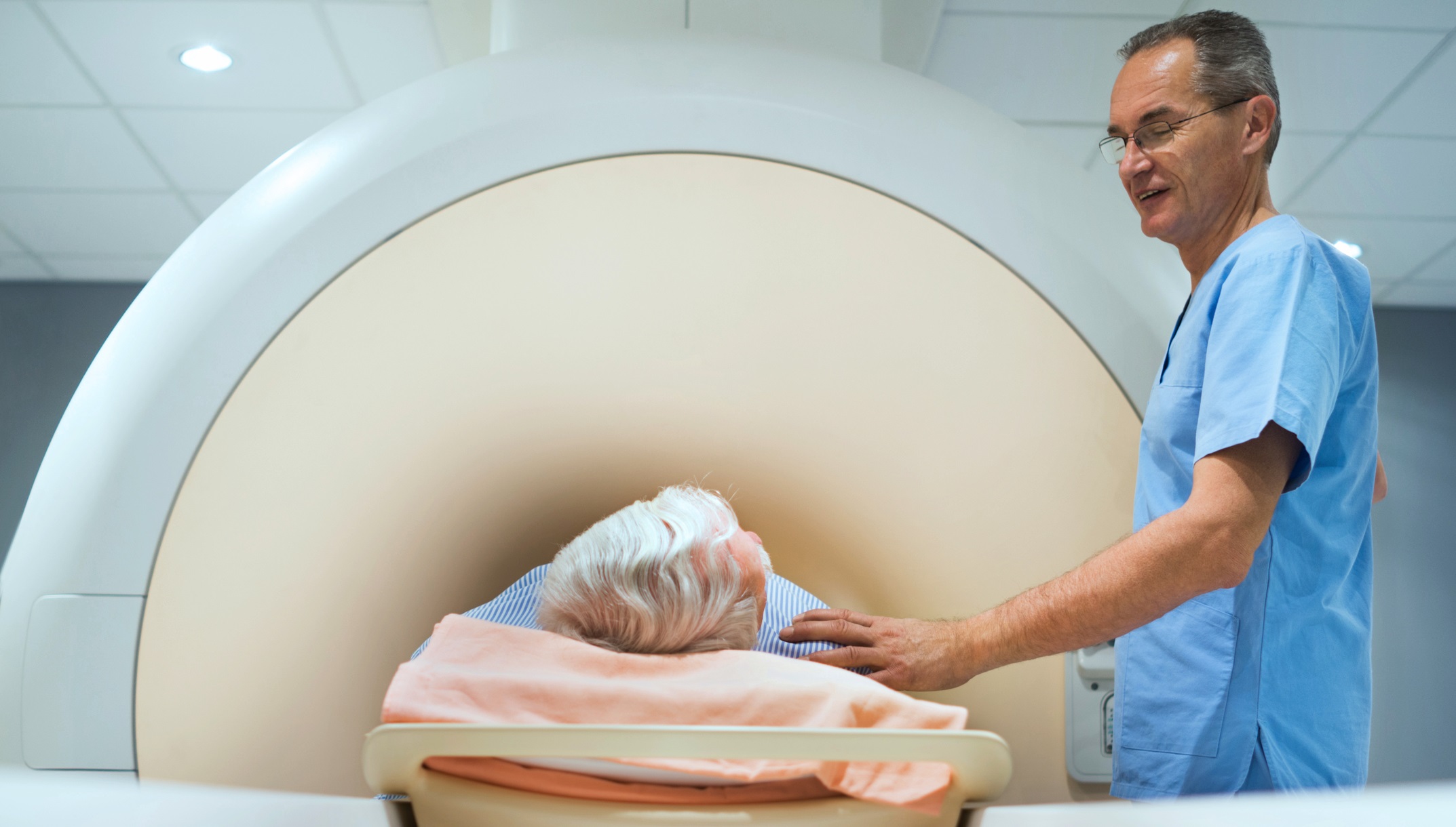Mature radiologist consoling patient before MRI scan. - California ...